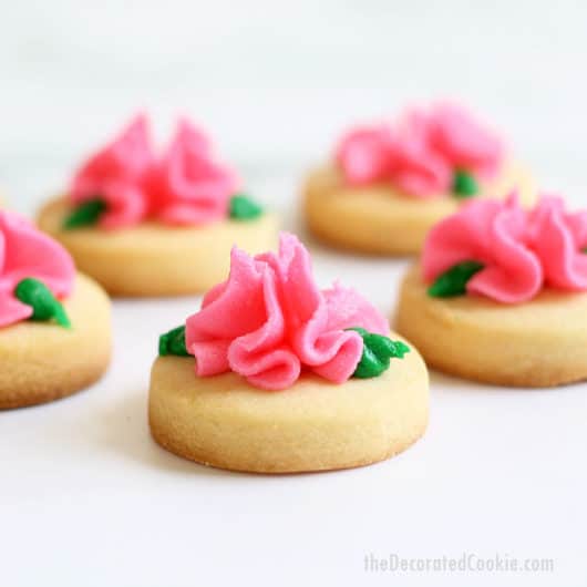 MINI ROSE COOKIES -- Buttercream frosting flowers on sugar cookies.